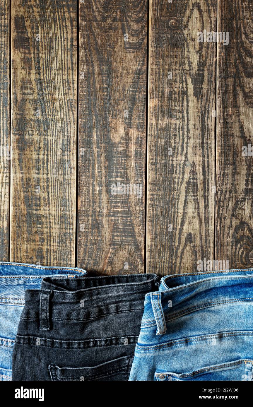 Textile background theme with different cotton jeans on an rustic wood ...