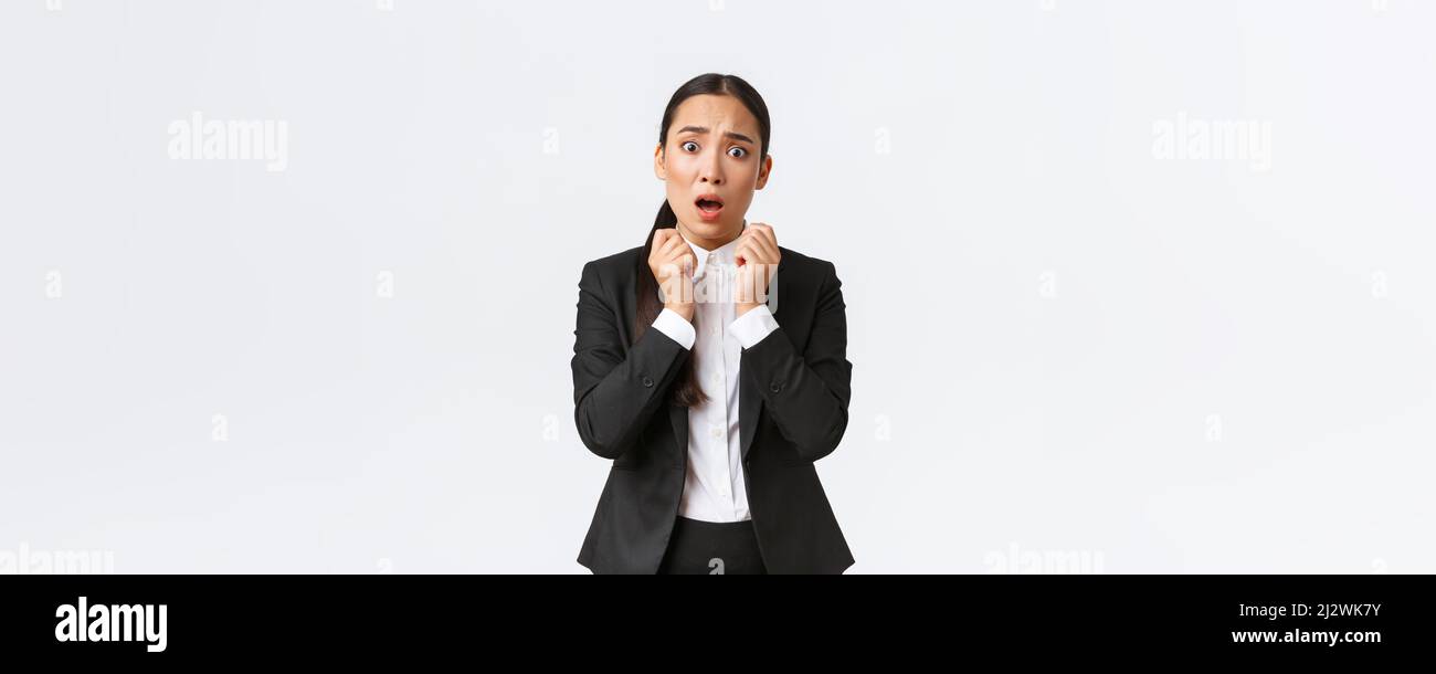 Worried and shocked asian female entrepreneur in suit hear worrying ...