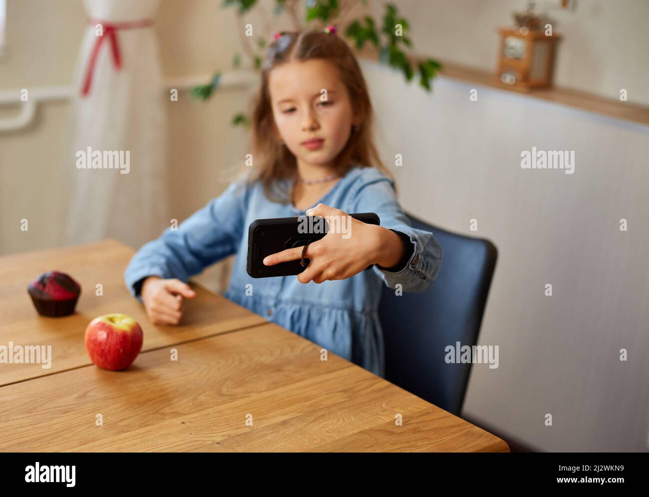 Beautiful young girl filming her blog broadcast about healthy food at ...