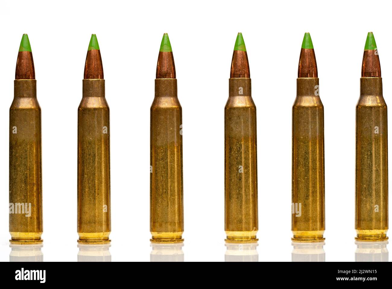 A group of 5.56 calibar, green tip bullets ordered into the line on ...