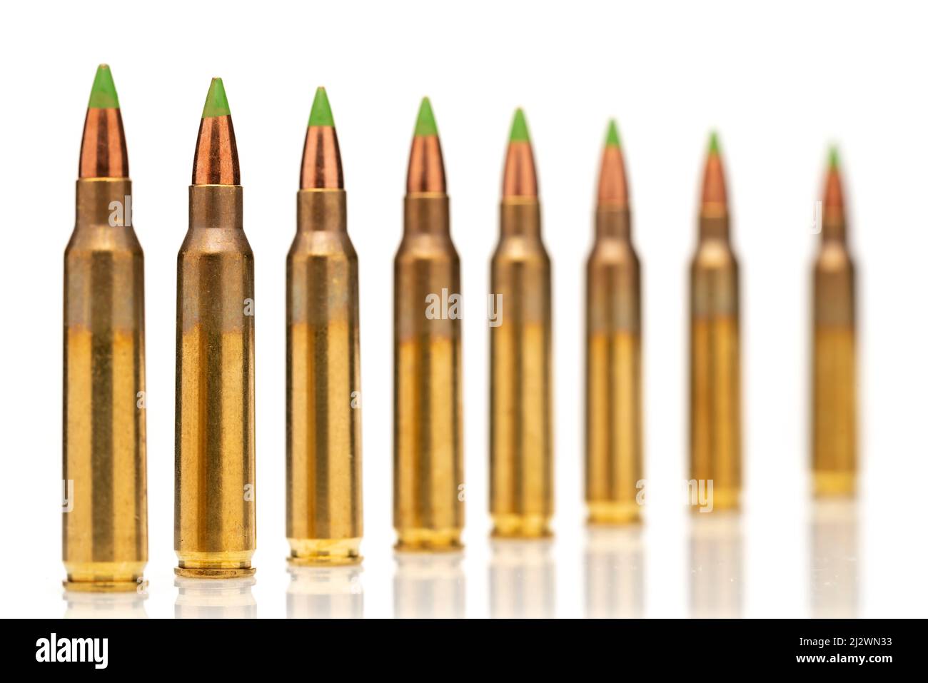 A group of 5.56 calibar, green tip bullets on white background Stock ...
