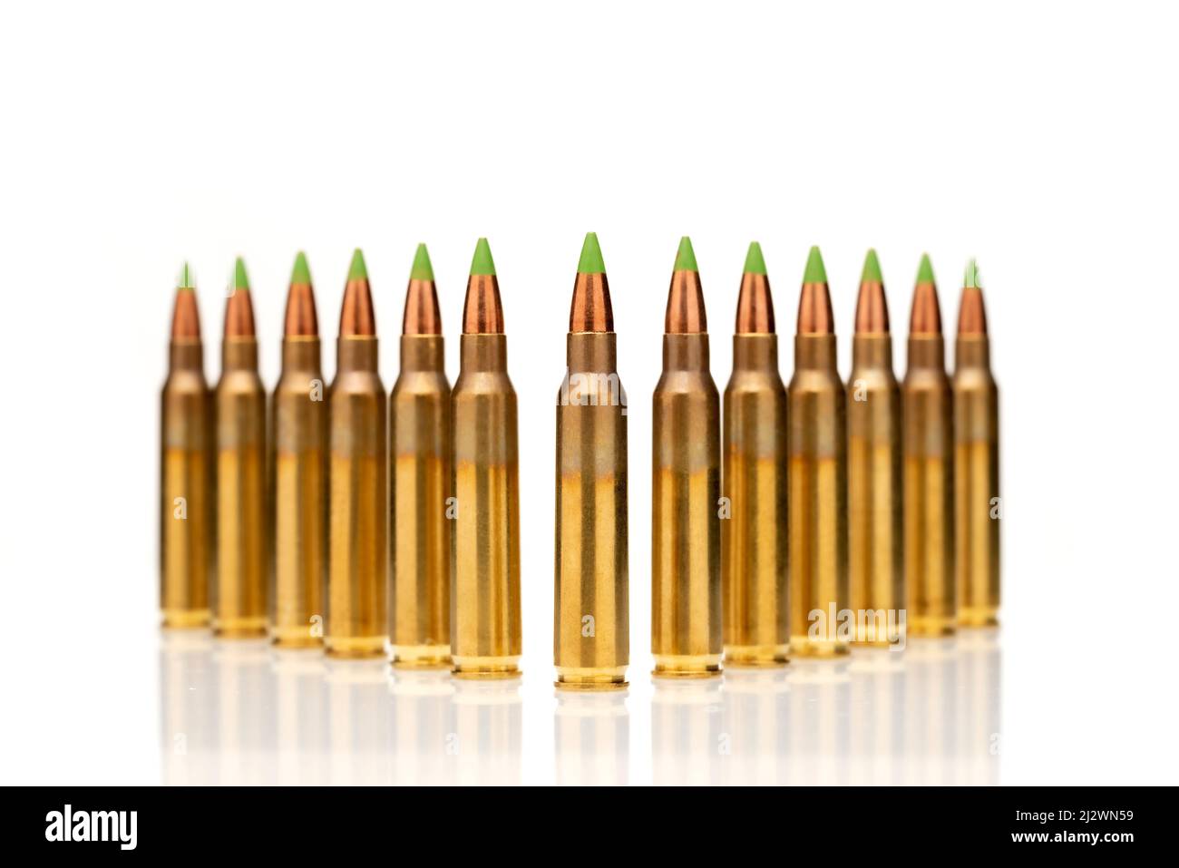 A group of 5.56 calibar, green tip bullets ordered into the lines on ...