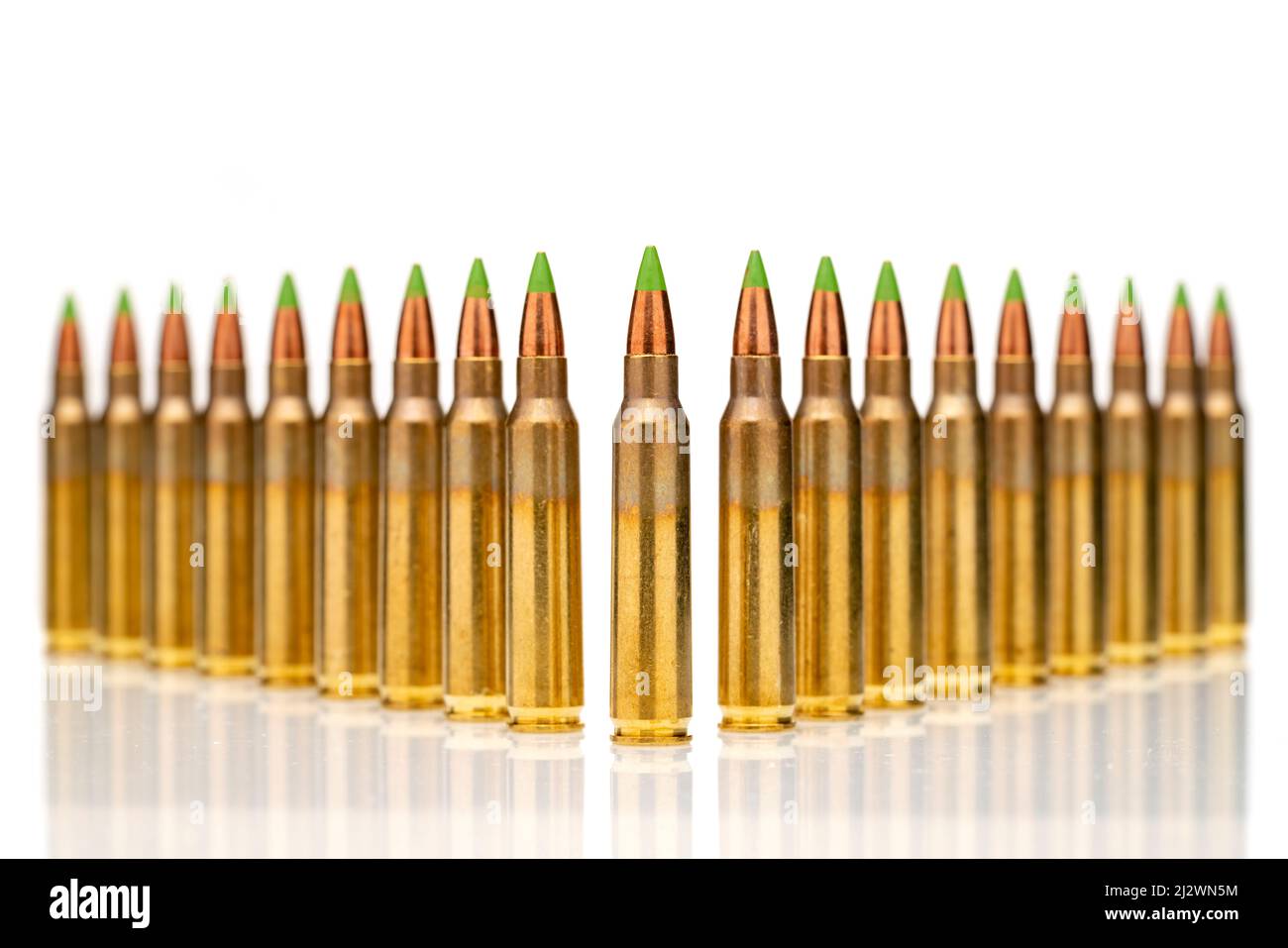 A group of 5.56 calibar, green tip bullets ordered into the line on ...