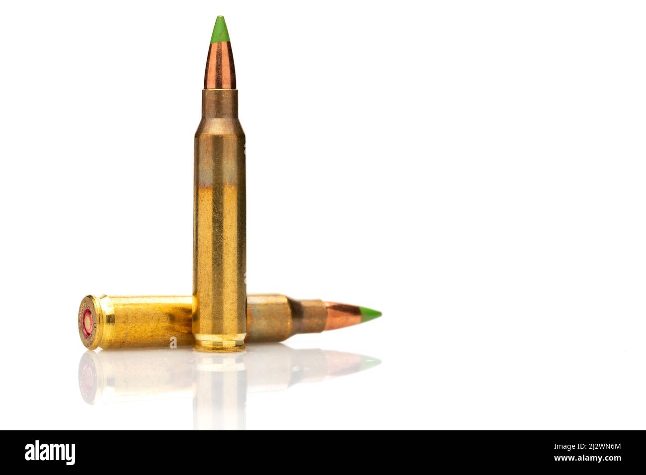 A pair of 5.56 calibar, green tip bullets on white background Stock ...