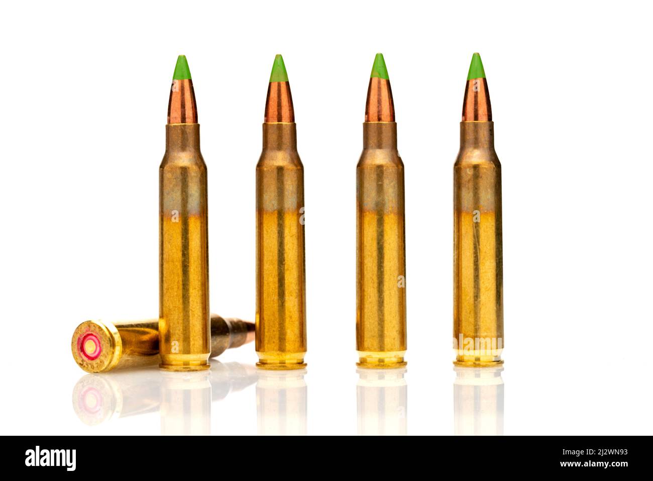 A group of 5.56 calibar, green tip bullets ordered into the line on ...