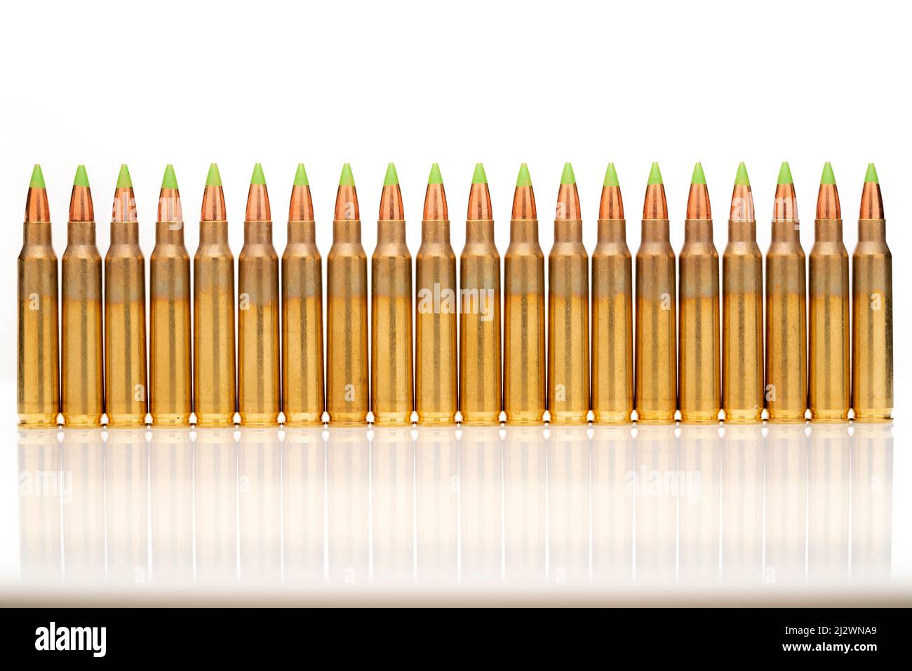 A group of 5.56 calibar, green tip bullets ordered into the line on ...