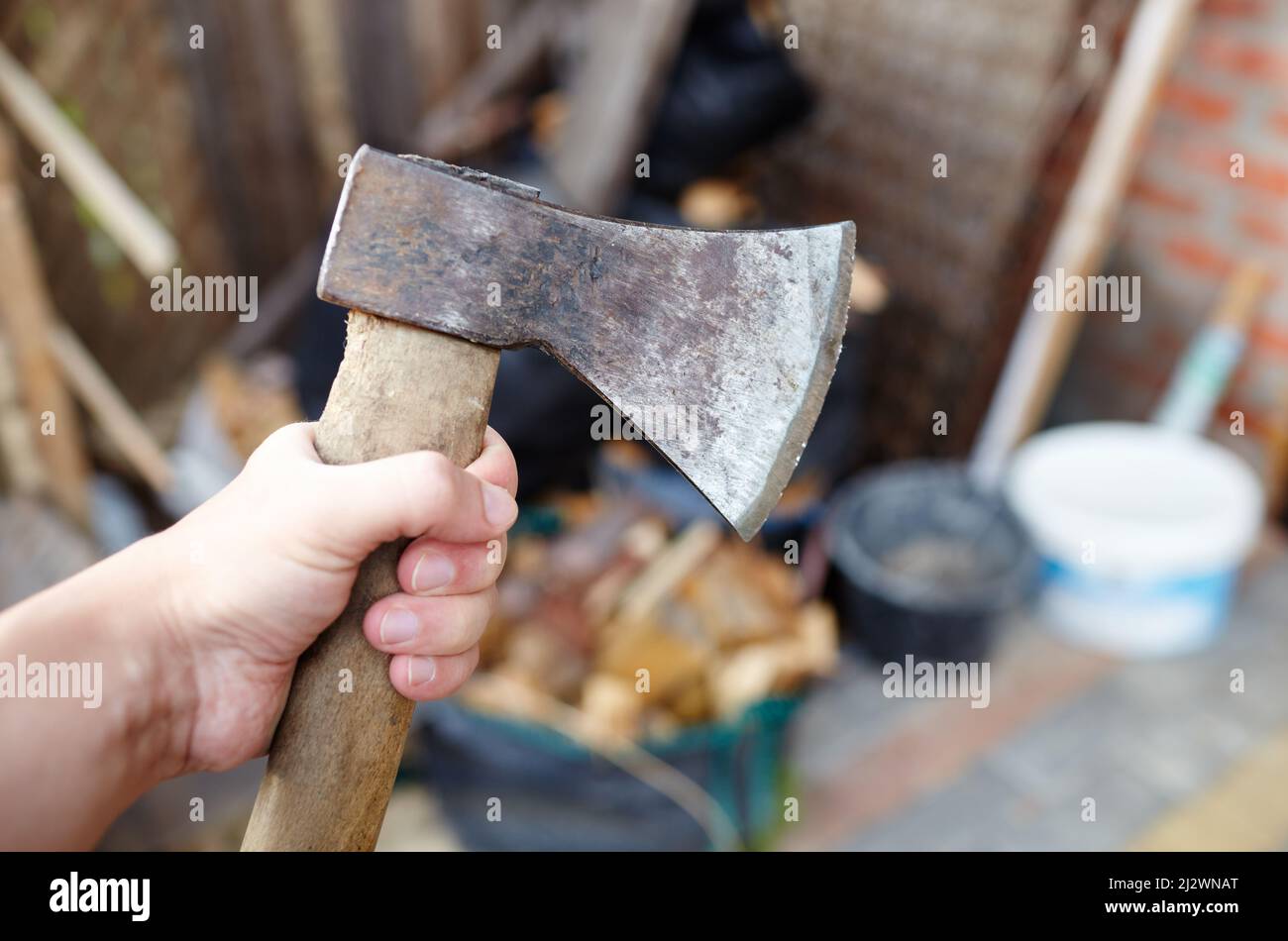 Man holding axe. Ax in hand. A strong man holds an ax in his hands ...