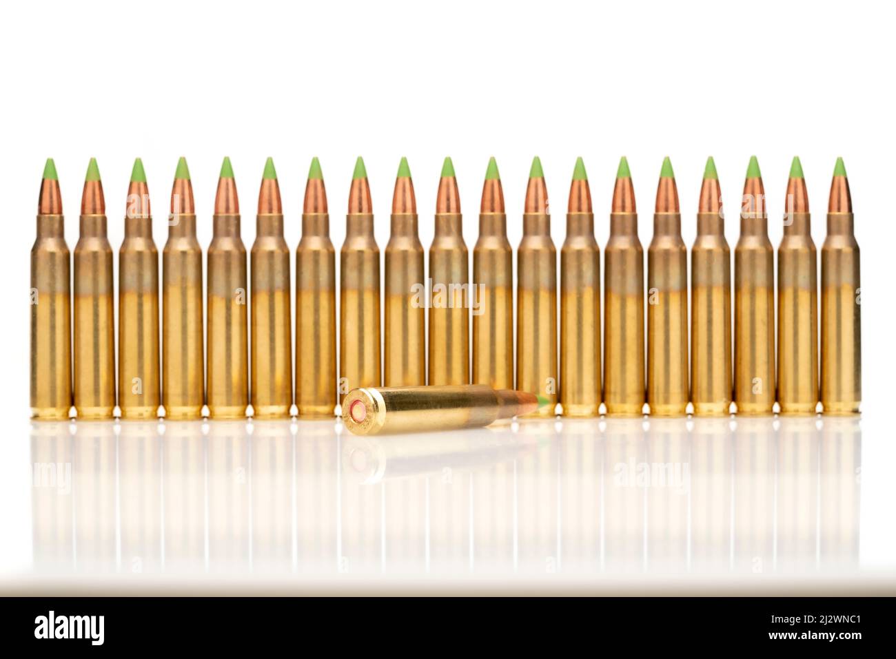 A group of 5.56 calibar, green tip bullets ordered into the line on ...