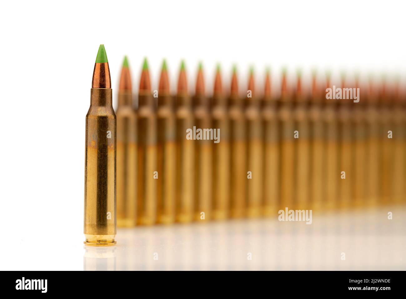 A group of 5.56 calibar, green tip bullets ordered into the line on ...