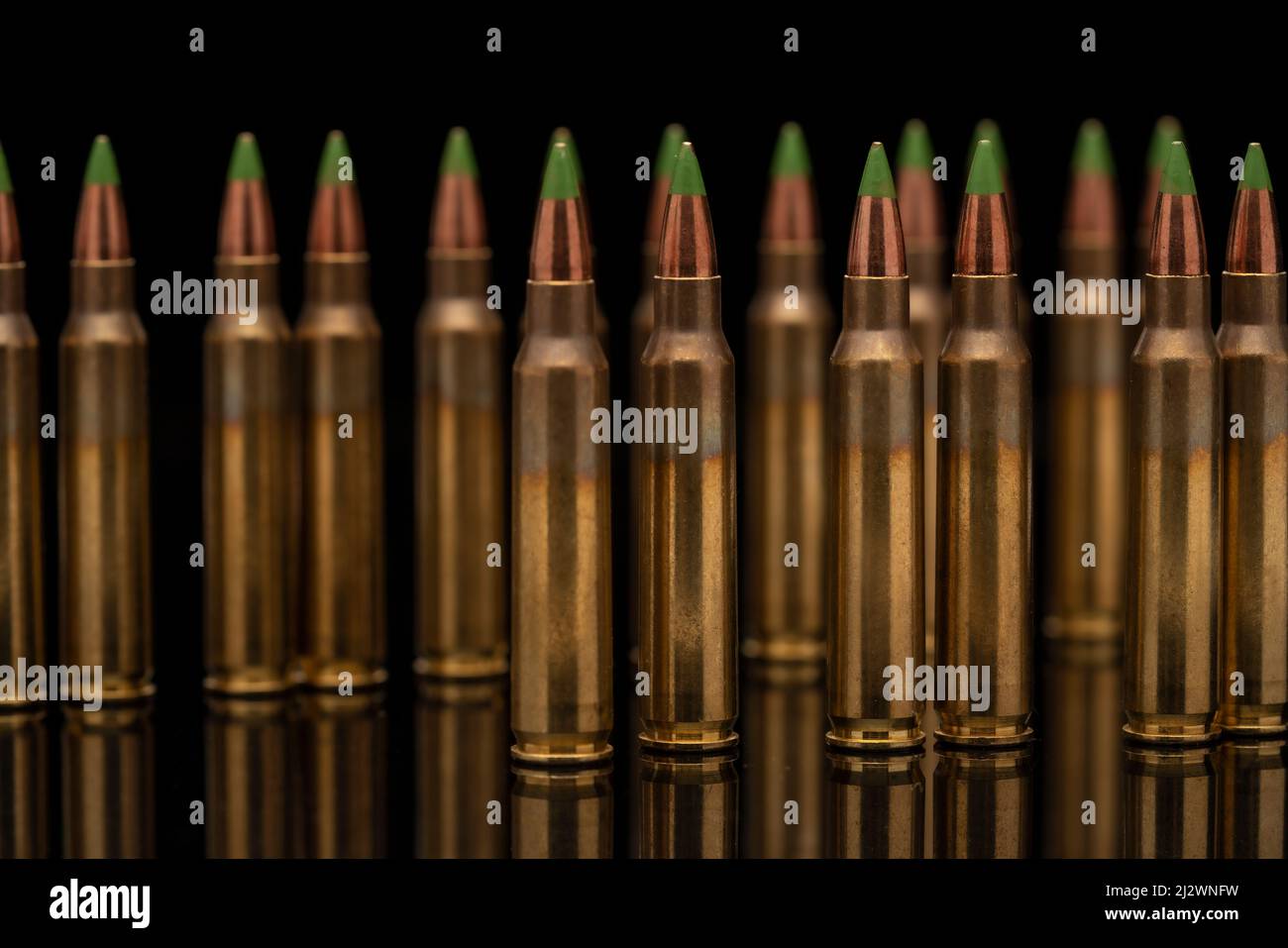 A group of 5.56 calibar, green tip bullets on black background Stock ...
