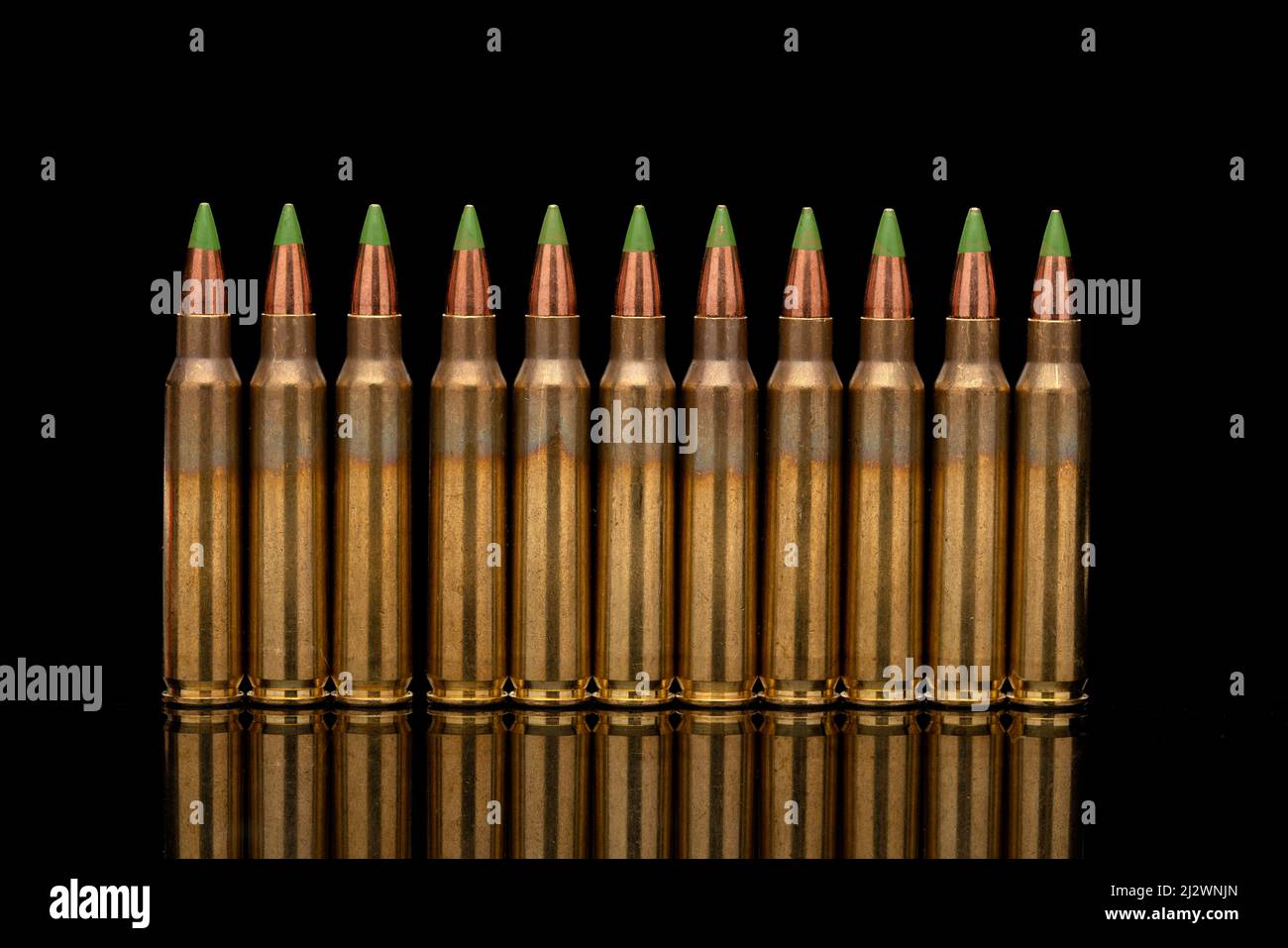 A group of 5.56 calibar, green tip bullets ordered into the line on ...