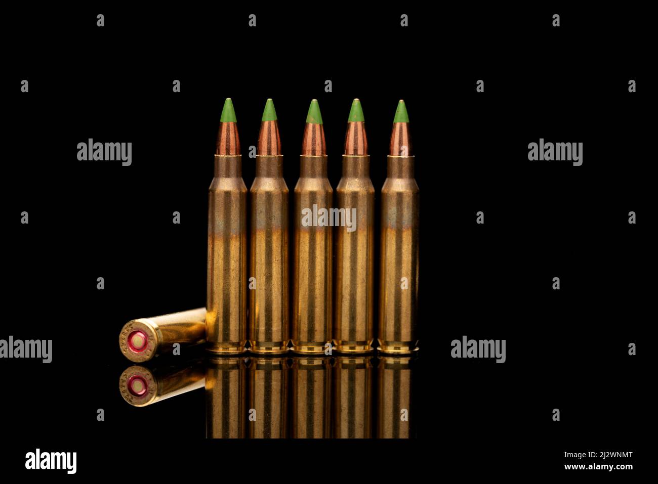 A group of 5.56 calibar, green tip bullets ordered into the line on ...