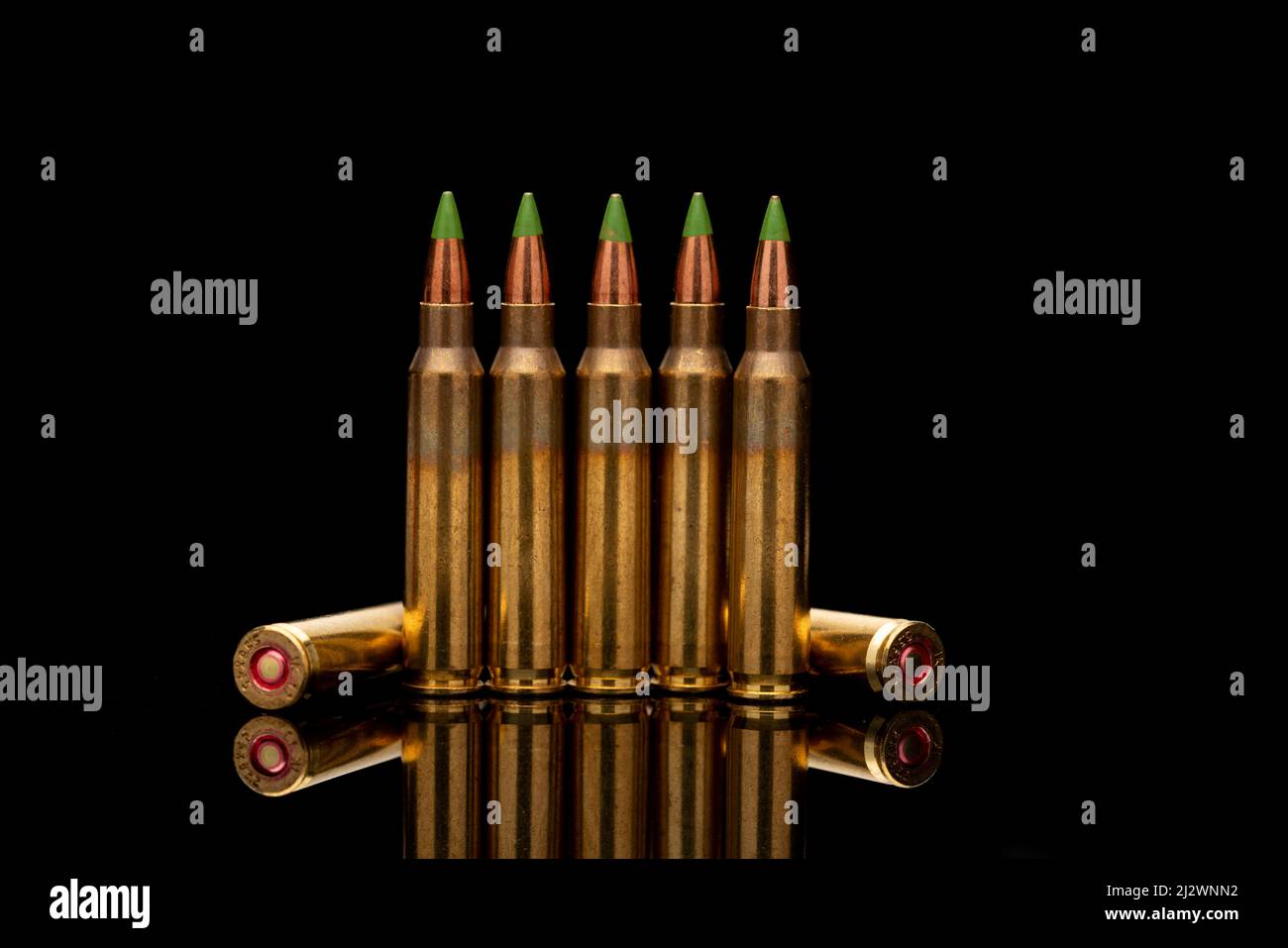 A group of 5.56 calibar, green tip bullets on black background Stock ...