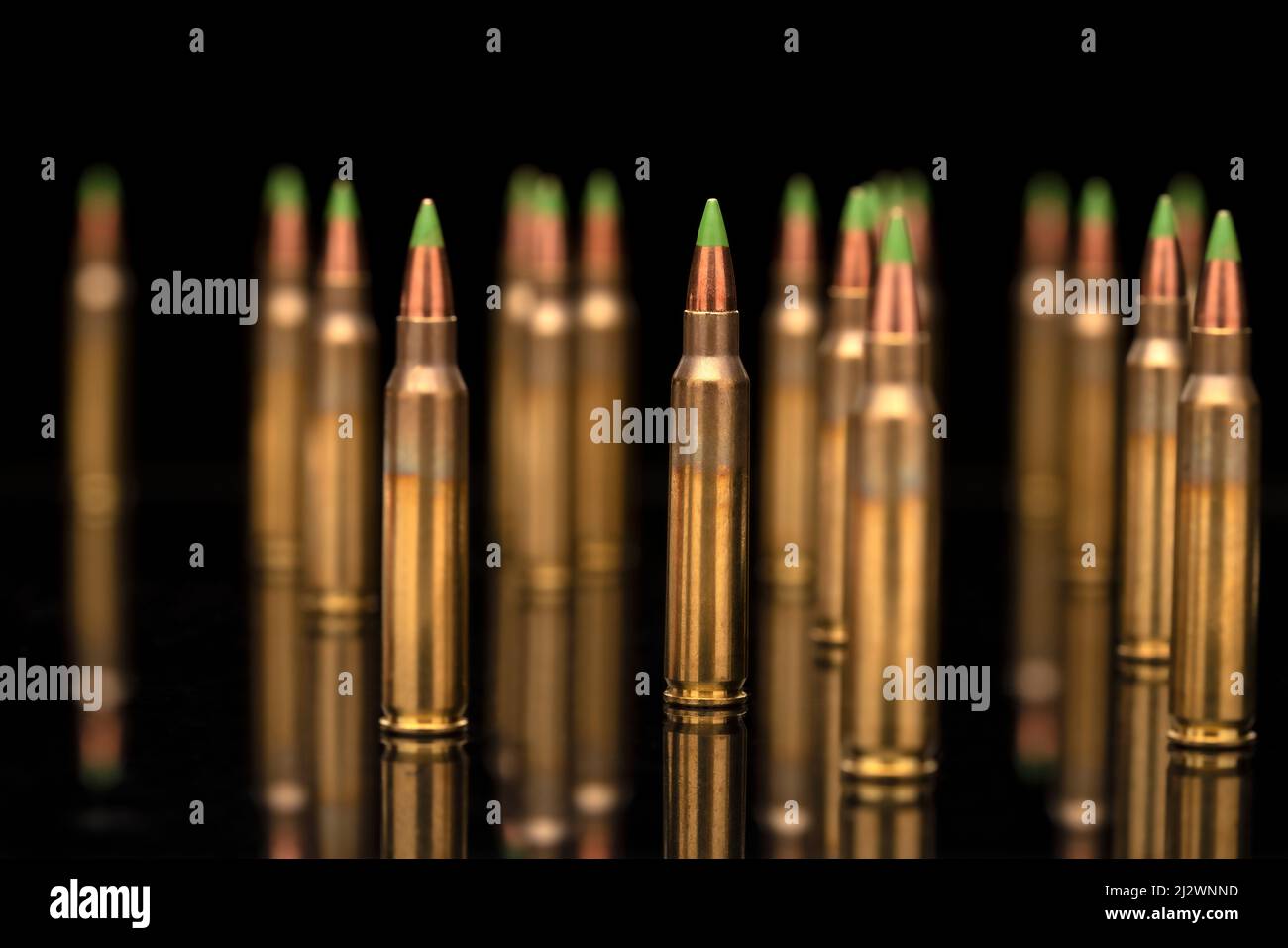A group of 5.56 calibar, green tip bullets on black background Stock ...