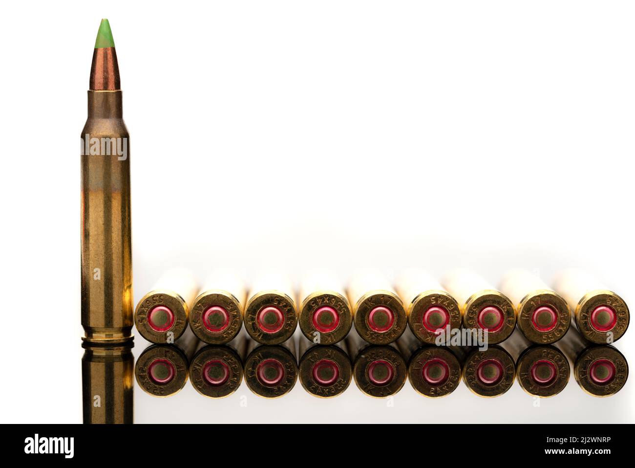 A group of 5.56 calibar, green tip bullets ordered into the line on ...