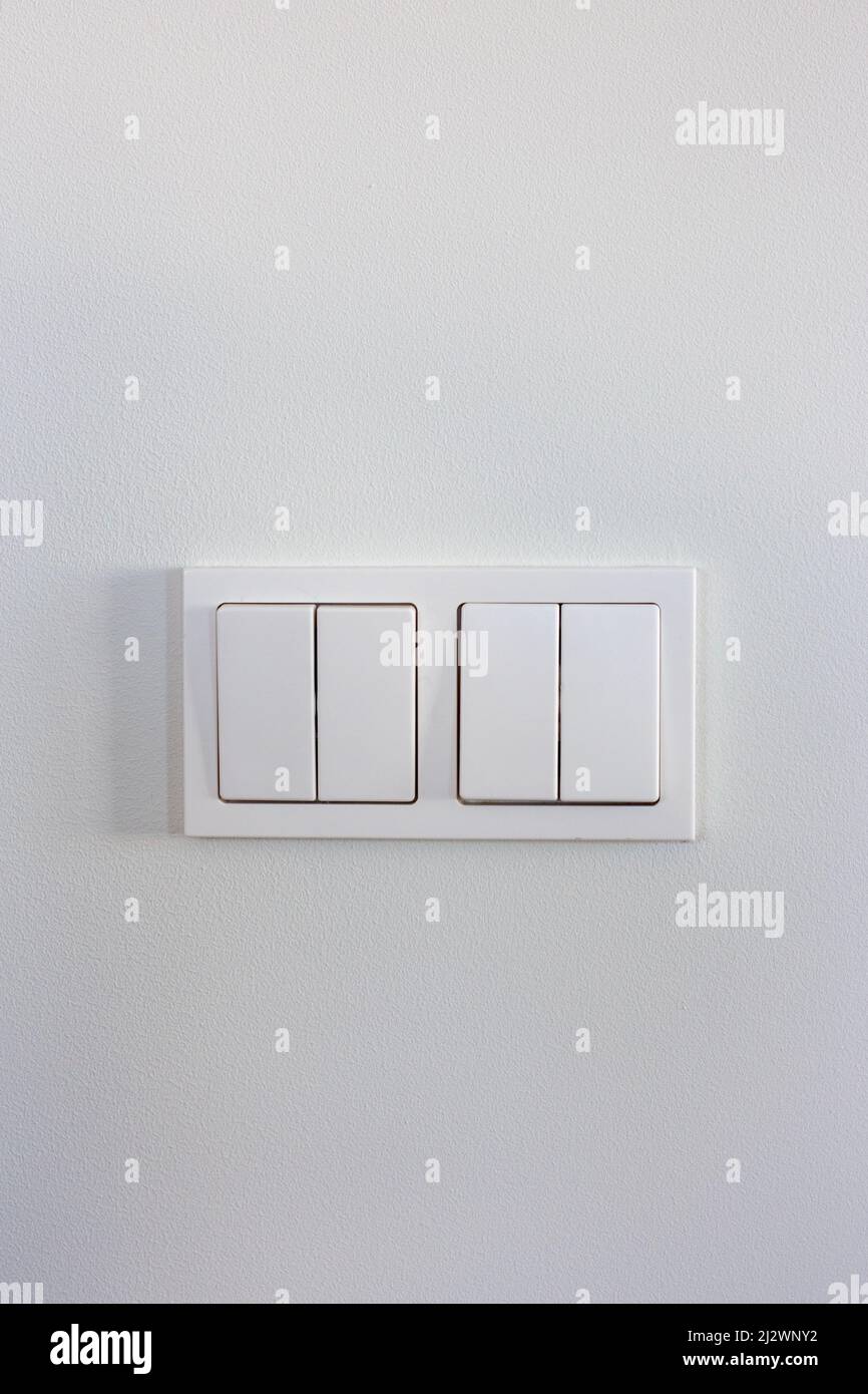 White light switches on a white wall Stock Photo - Alamy