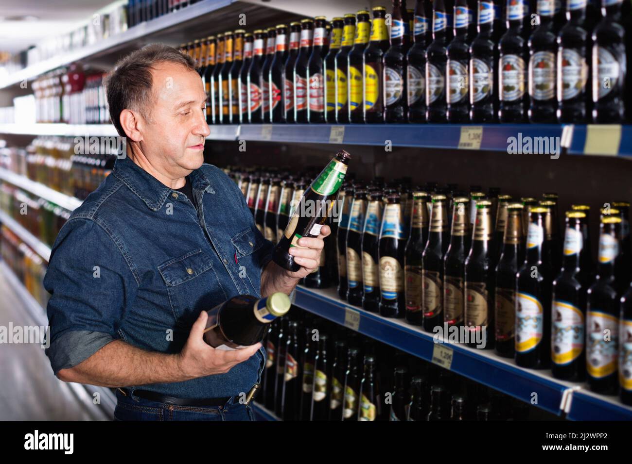 European selecting a beer at the grocery store Stock Photo - Alamy