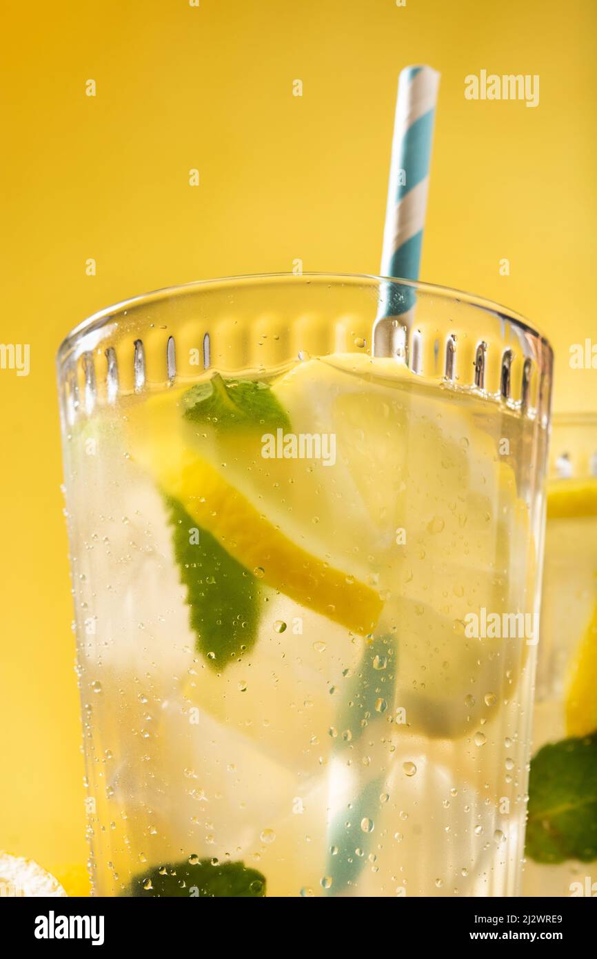 Glass of fresh lemonade on yellow background Stock Photo - Alamy
