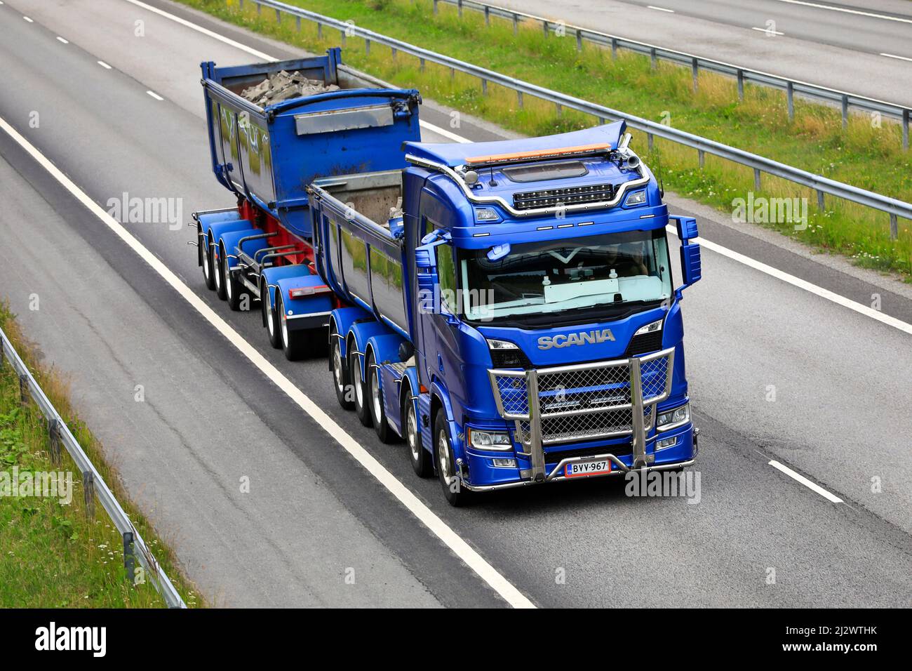 Customised blue Scania truck in front of cassette trailer hauls load ...