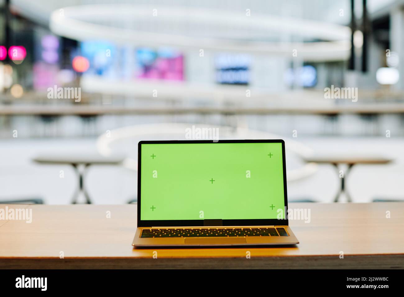 Background image of opened laptop with green screen chroma key on table ...