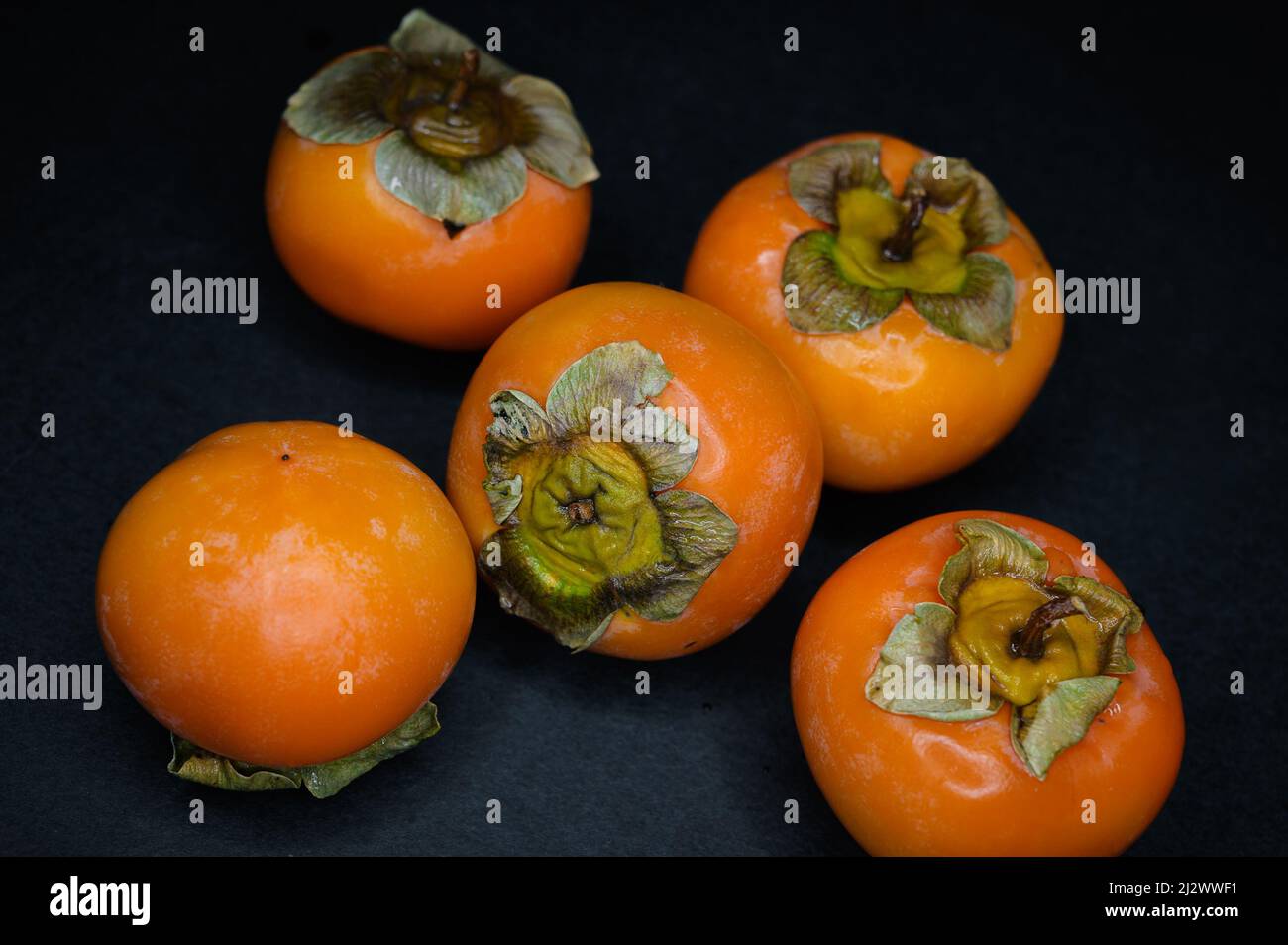 Three ripe persimmon fruits hi-res stock photography and images - Alamy