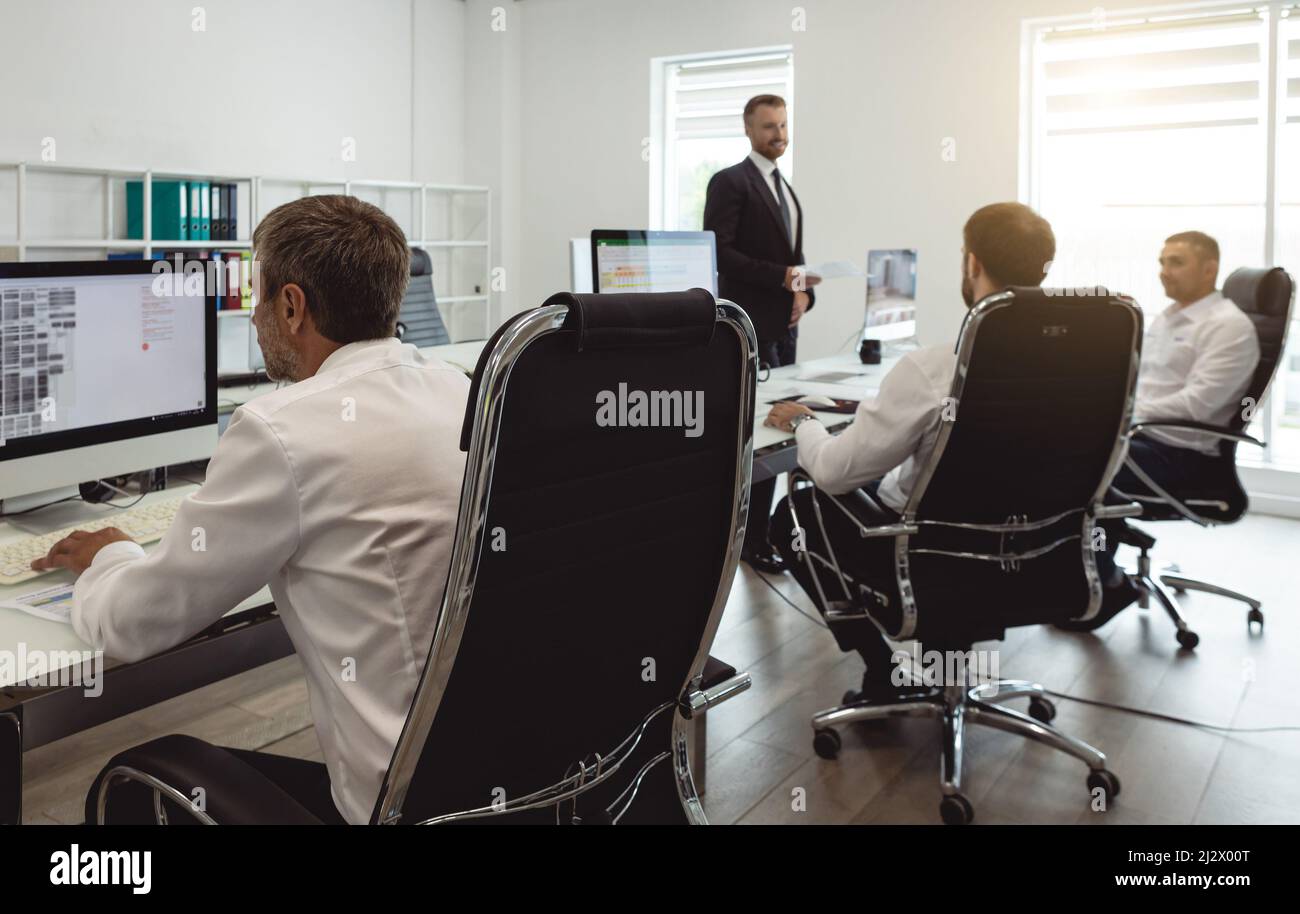 The chief manager and employees of the company interact and talk in the ...
