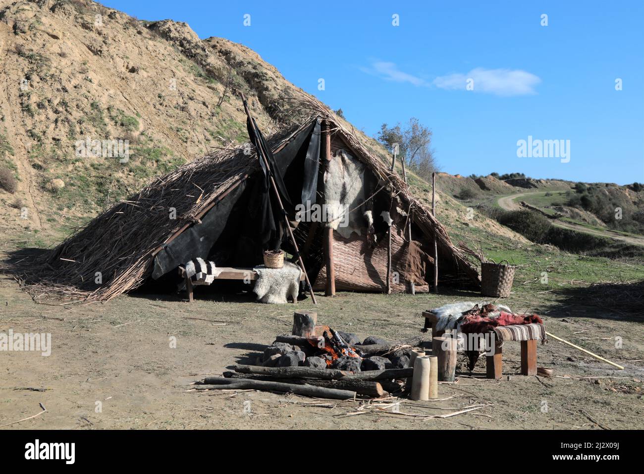 A reed tent on a mountain slope. There are old furniture and fire in ...