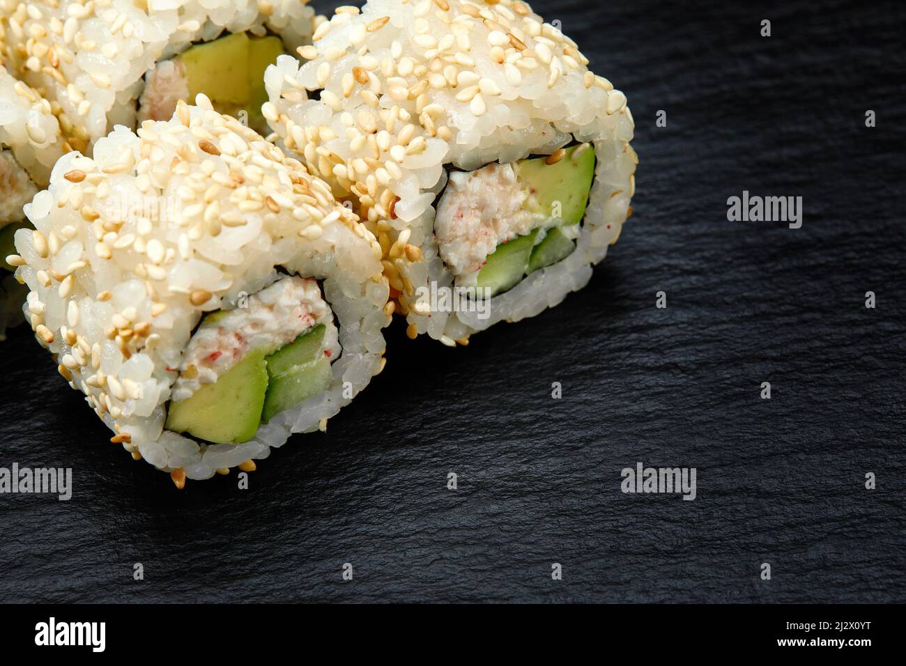 Traditional delicious fresh sushi roll set on a black background. Sushi ...