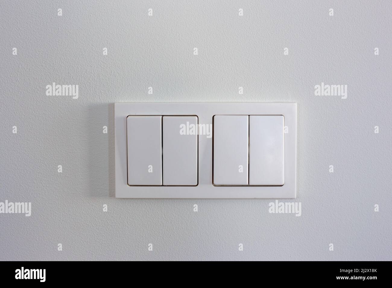 White light switches on a white wall Stock Photo - Alamy
