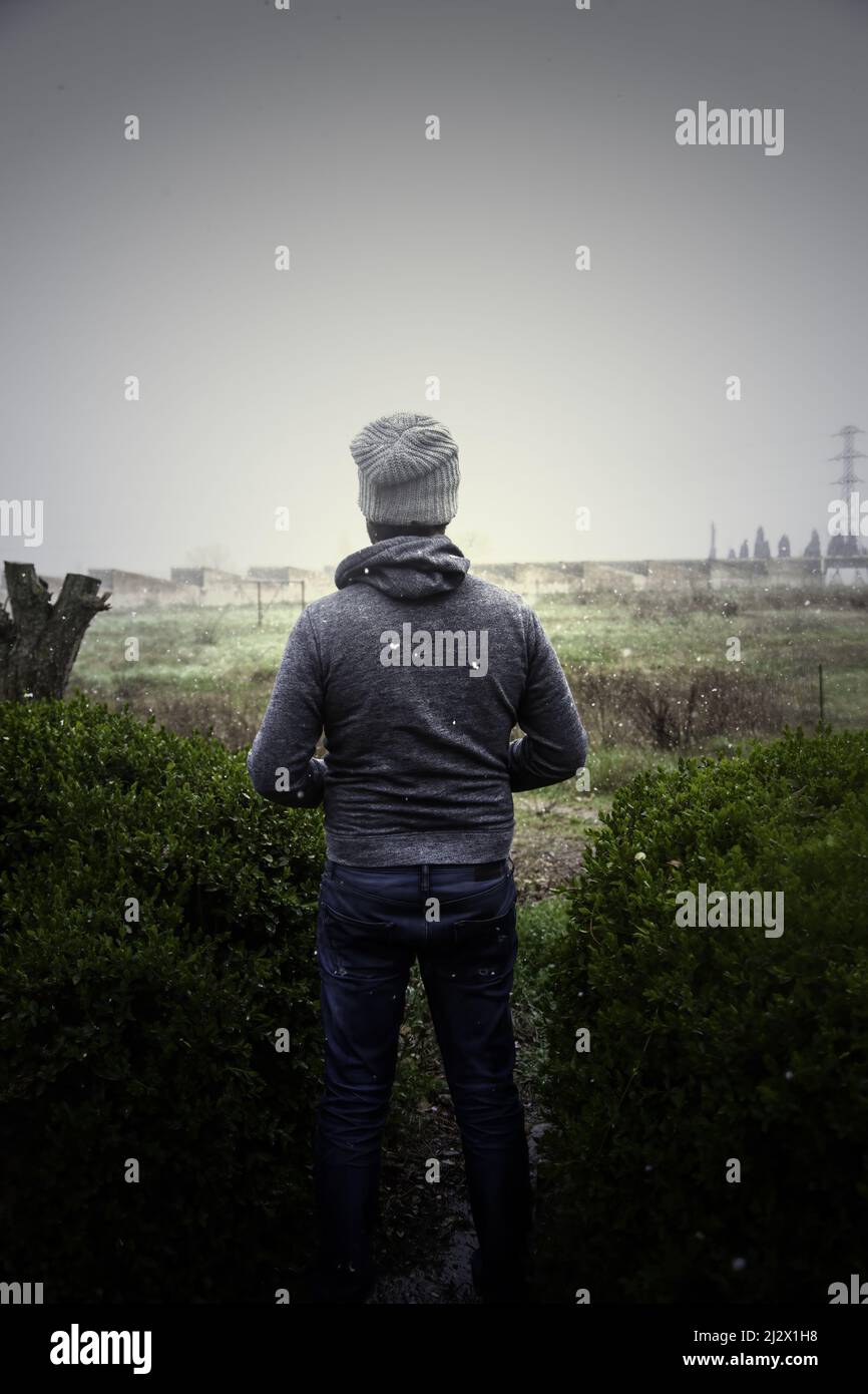 Lonely man under snow in natural landscape, bad weather Stock Photo - Alamy