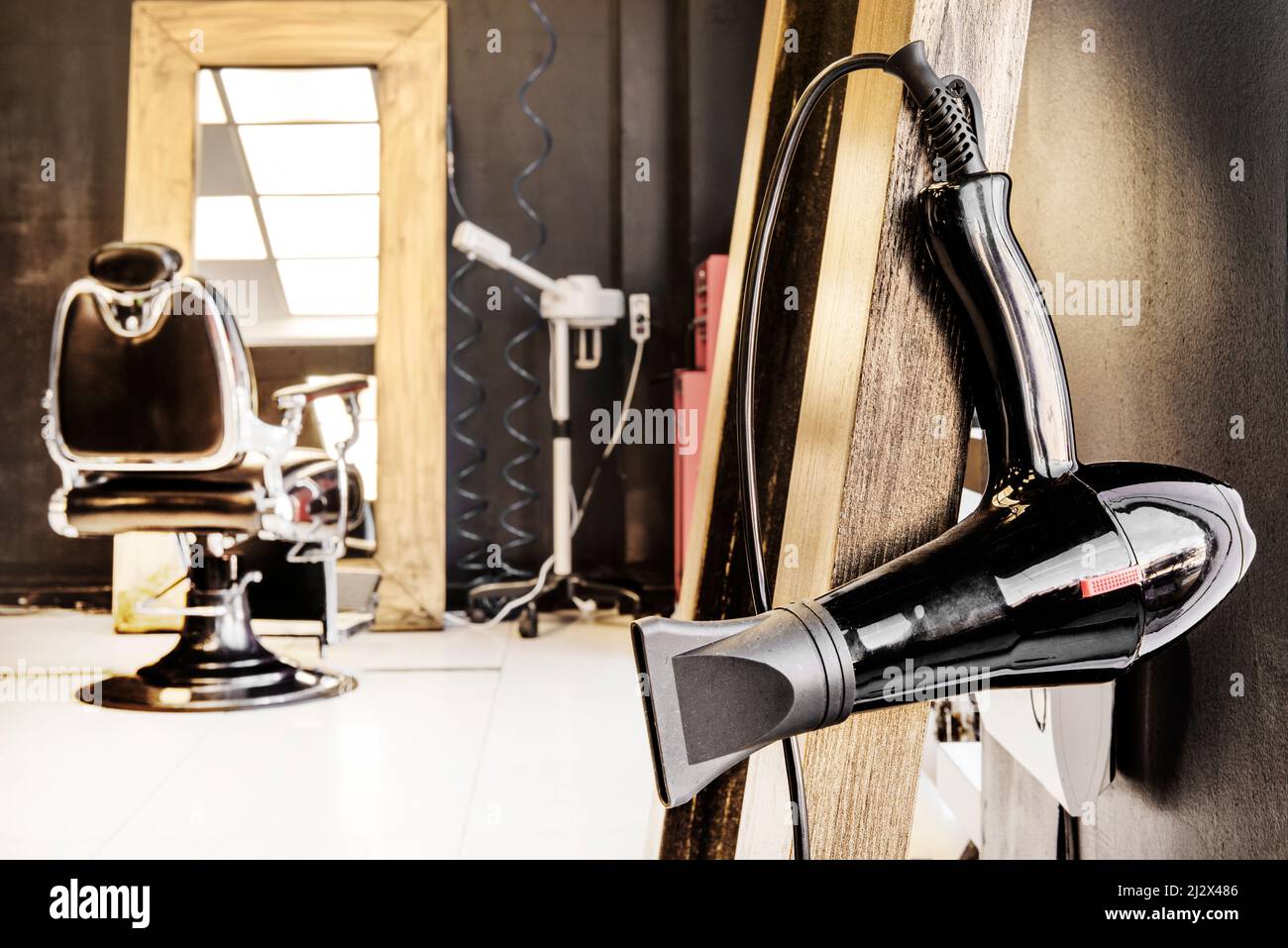Close-up of a hair dryer in a typical urban barber shop setting with ...