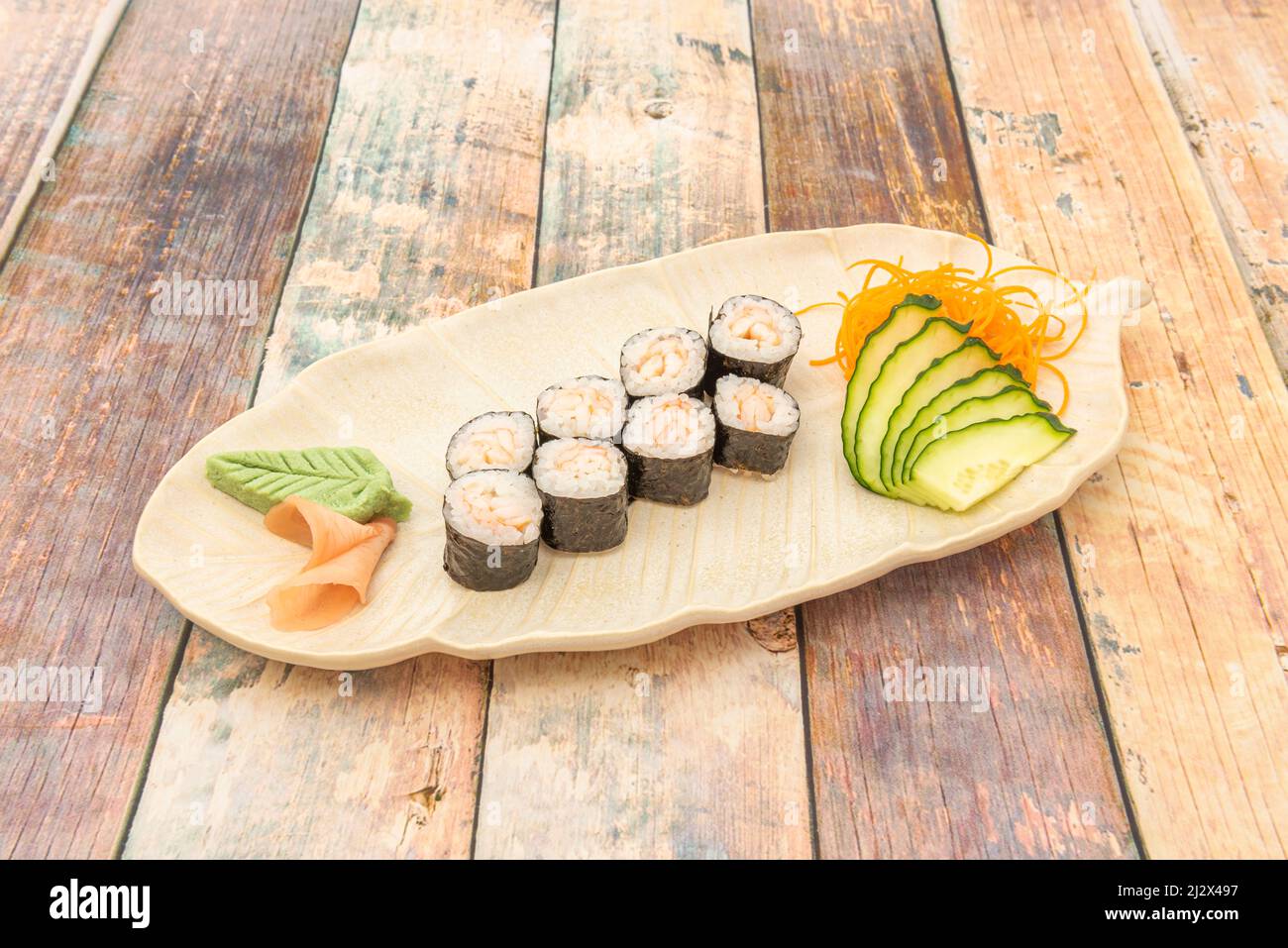 White tray of maki sushi stuffed with rice with surimi and wrapped in ...