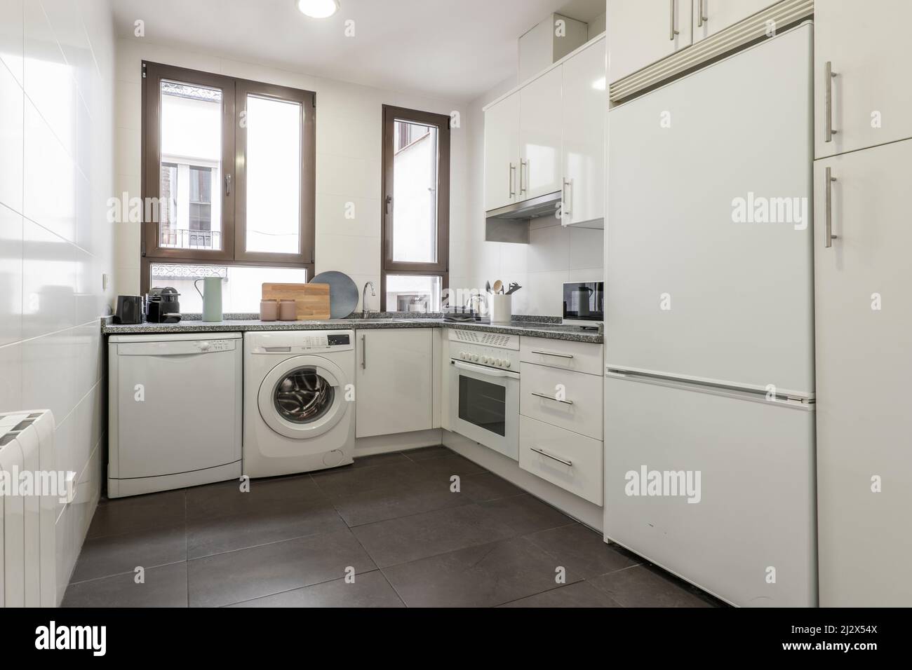 White kitchen with matching appliances, gray granite counter top and ...
