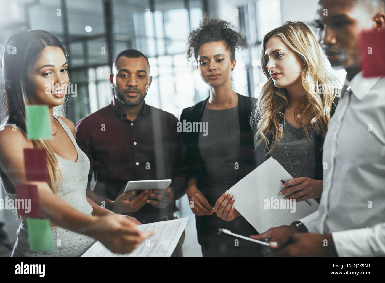 Chasing the next big idea in business. Shot of a group of young ...