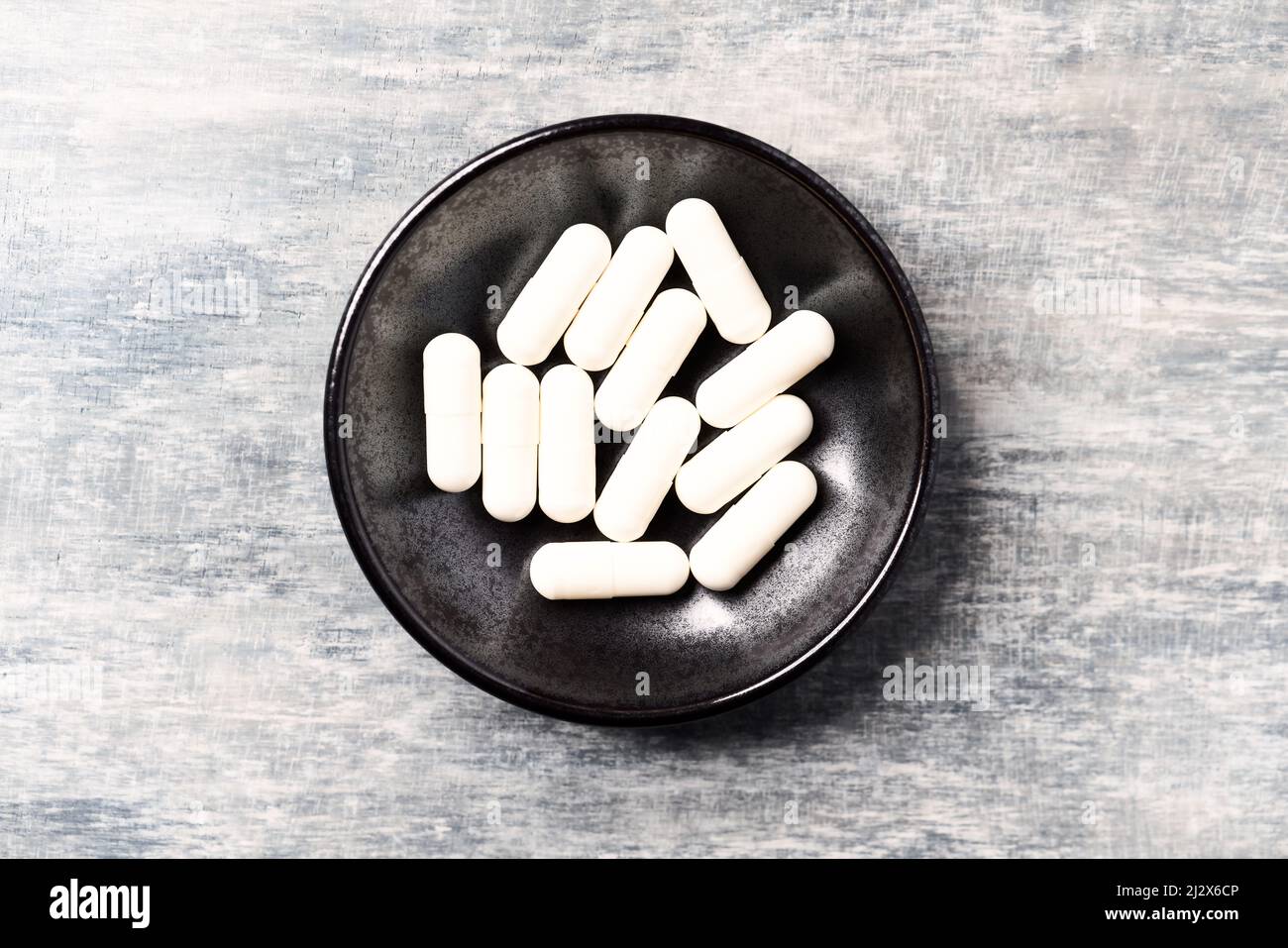 Beta-alanine capsules. Bodybuilding food supplements on wooden ...