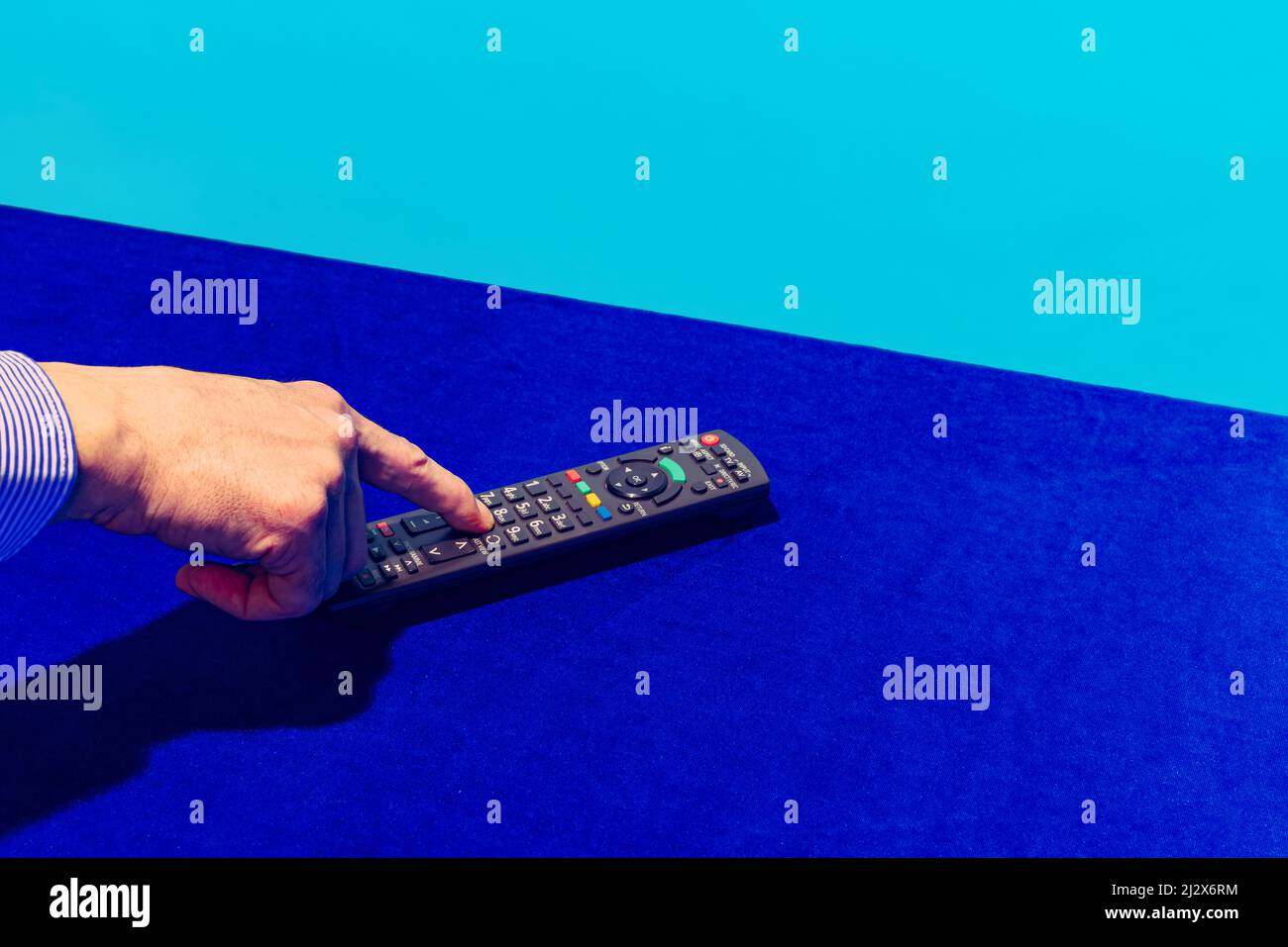 Pop art photography. Female hand press button on remote control ...