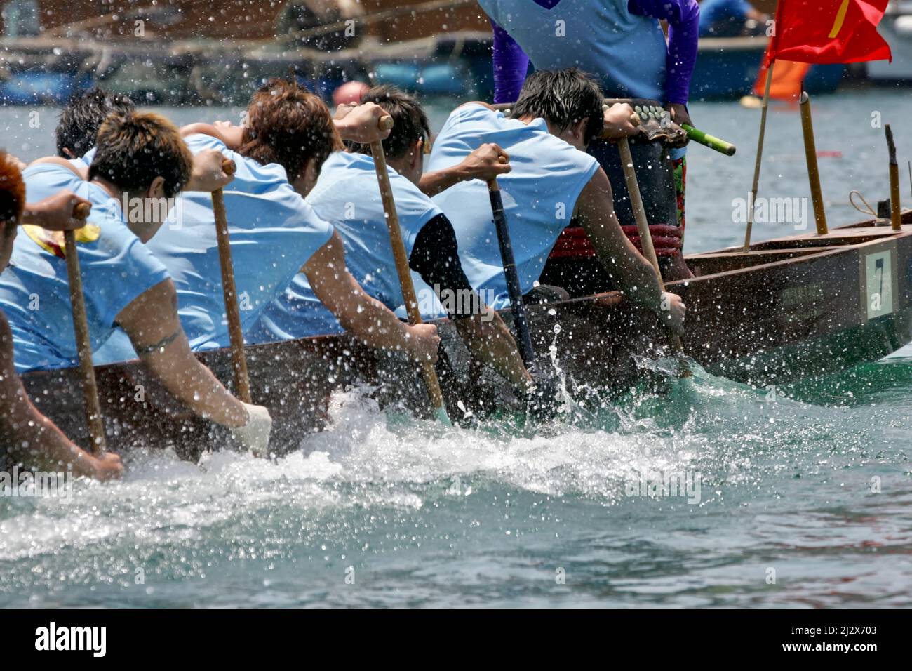 crew racing a dragon boat Stock Photo - Alamy