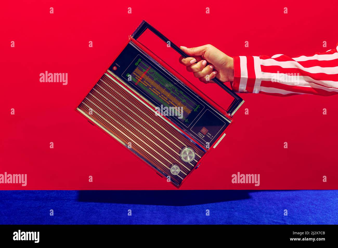 Retro radio. Female hand holding, touching radioreceiver isolated on ...