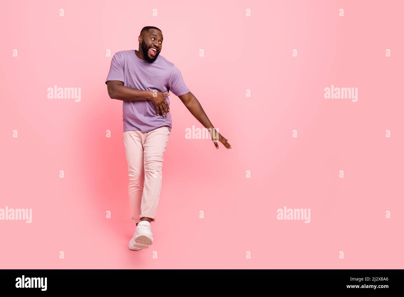 Photo of pretty sweet guy wear purple t-shirt dancing empty space ...