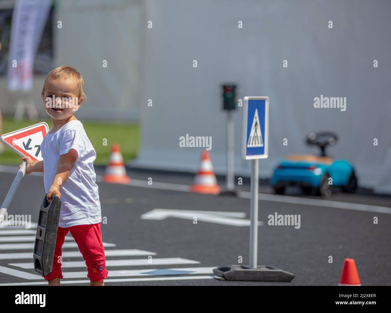Toddler enjoying first traffic education on an outdoor practice ground ...