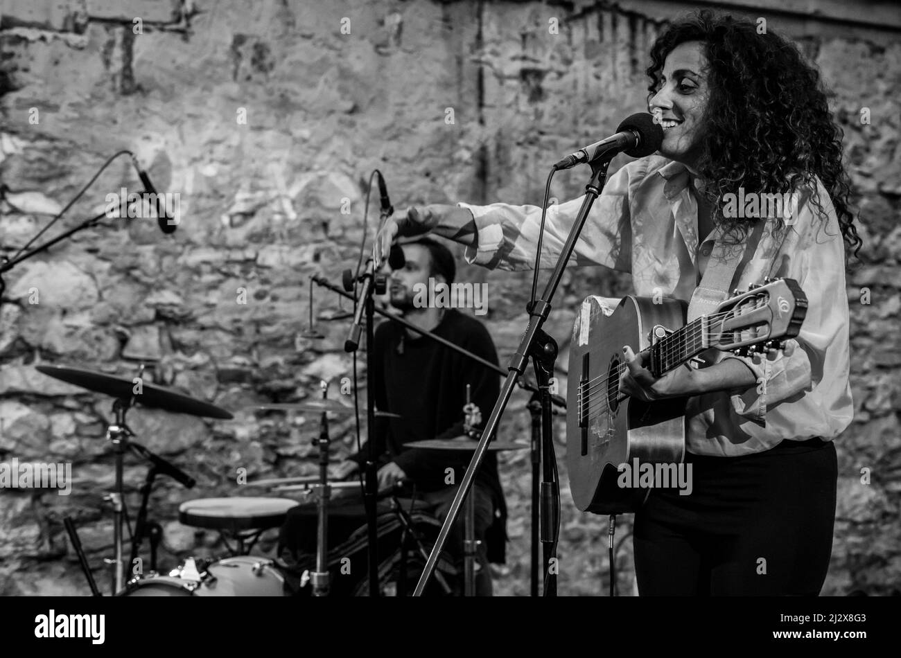 Young female singer singing and playing guitar in a live Stock Photo ...