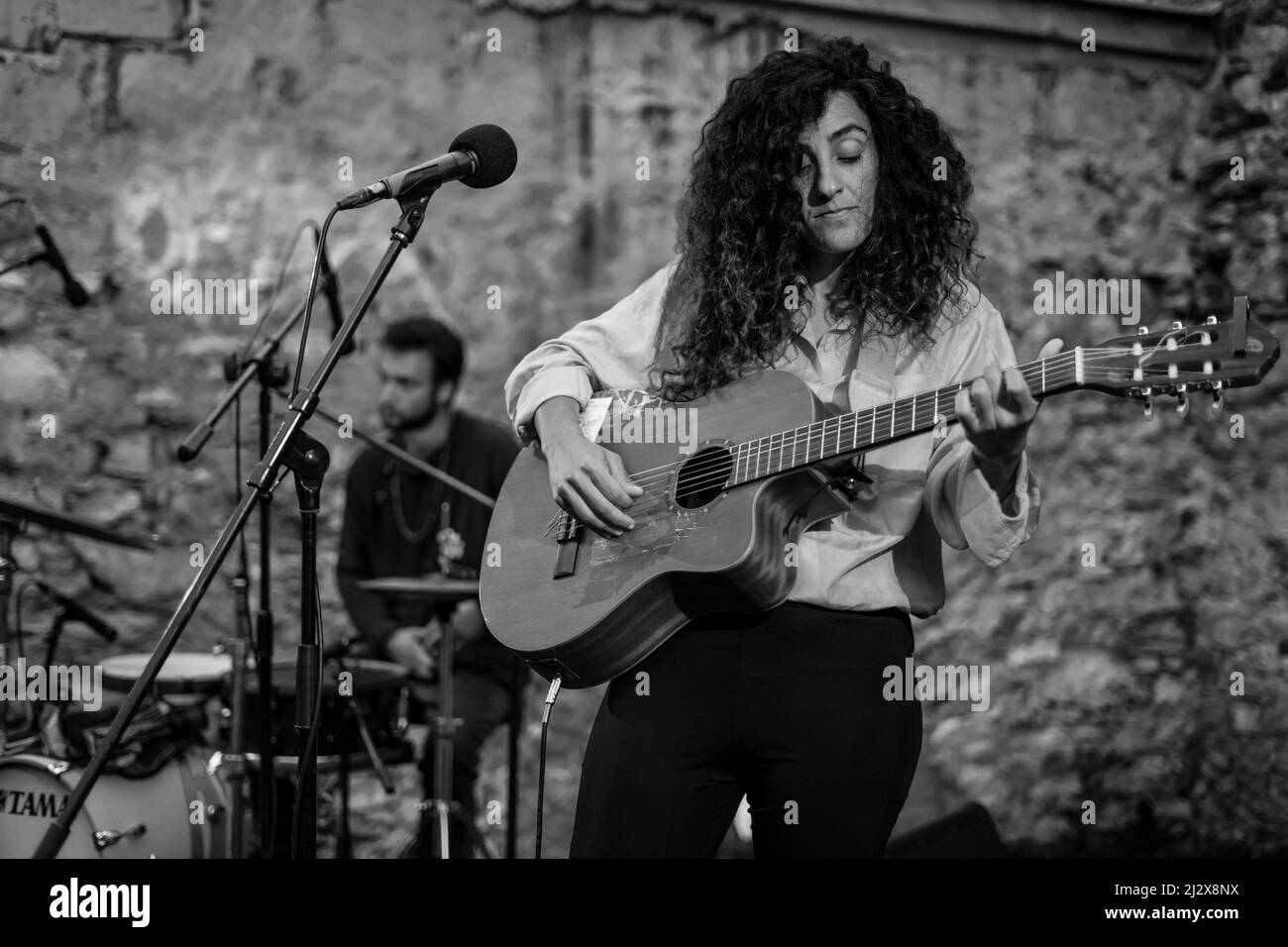 Young female singer singing and playing guitar in a live Stock Photo ...