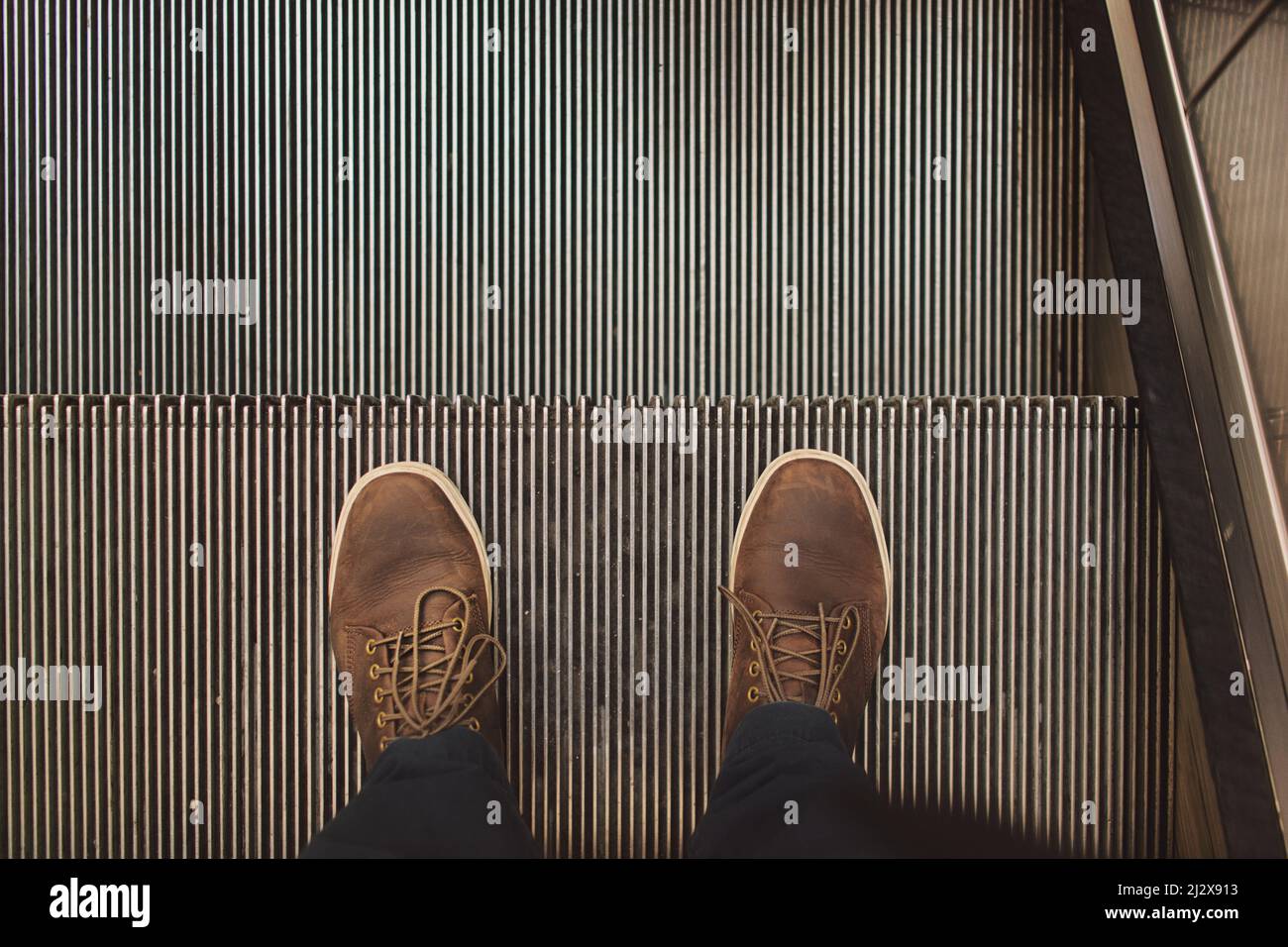 Shoes on escalator hi-res stock photography and images - Alamy