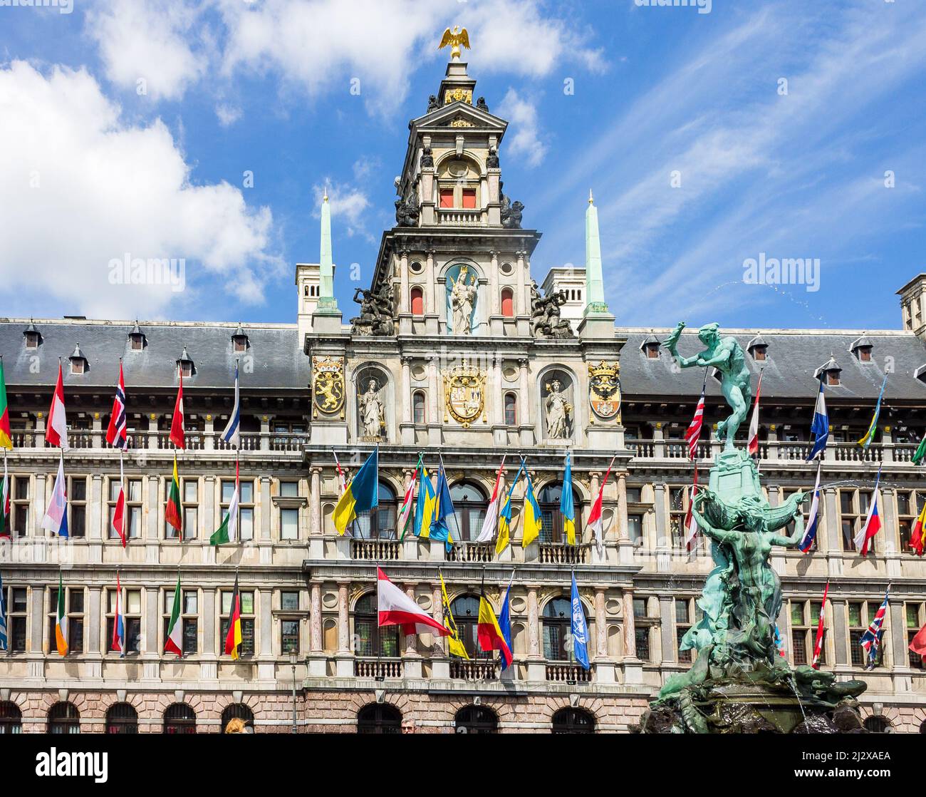 The exterior of the Brabo monument with sculptures and flags in Antwerp ...