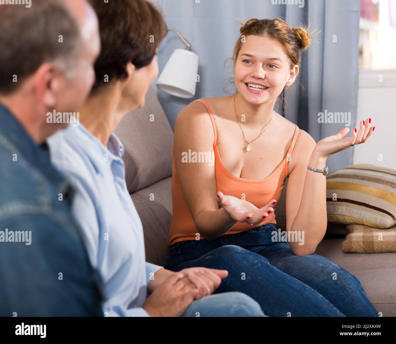 Happy family is talking about life on the sofa at home Stock Photo - Alamy