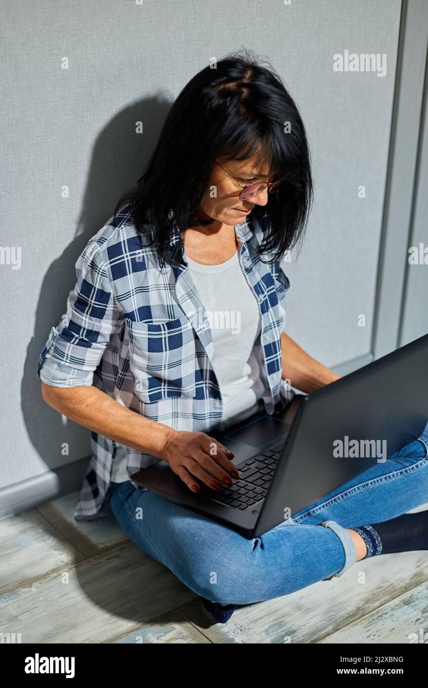 Senior woman female using typing on laptop keyboard, working, writing ...