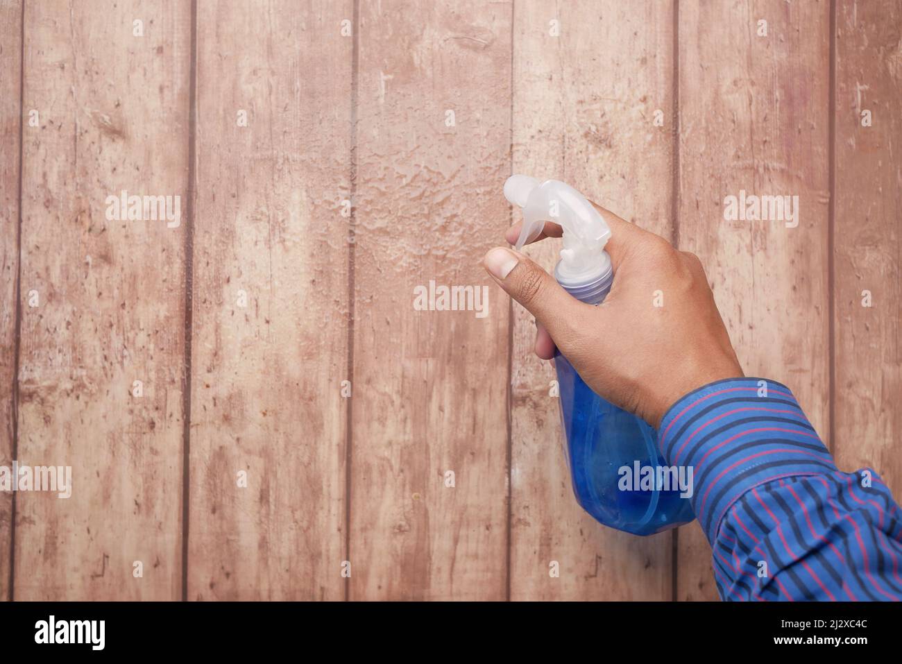 using disinfectant spray to clean table surface Stock Photo - Alamy
