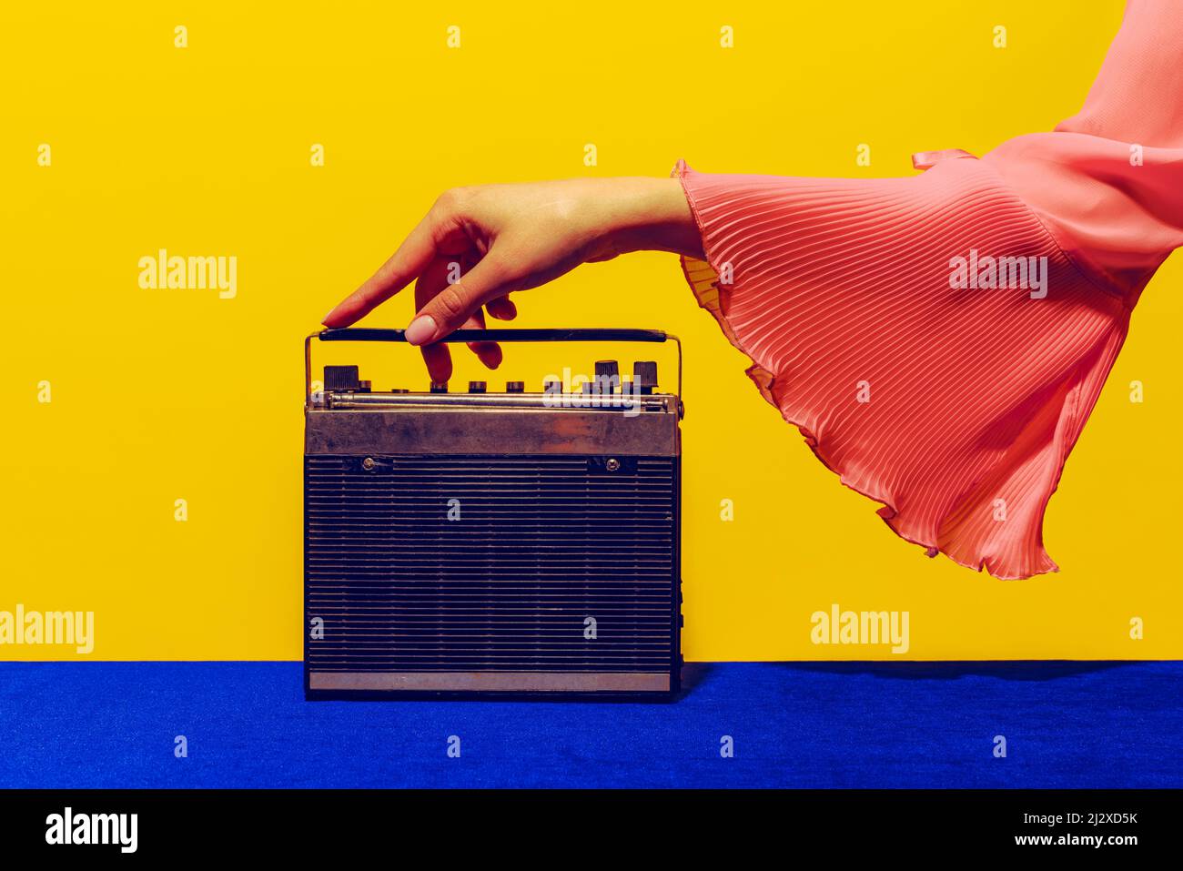 Old radio. Female hand touching radior, wireless isolated on bright ...