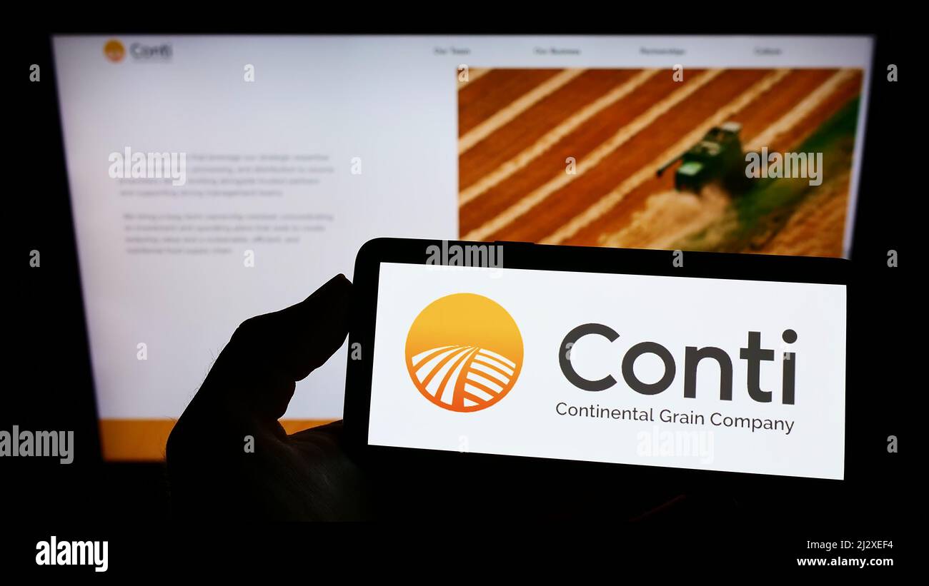 Person holding cellphone with logo of American business Continental ...