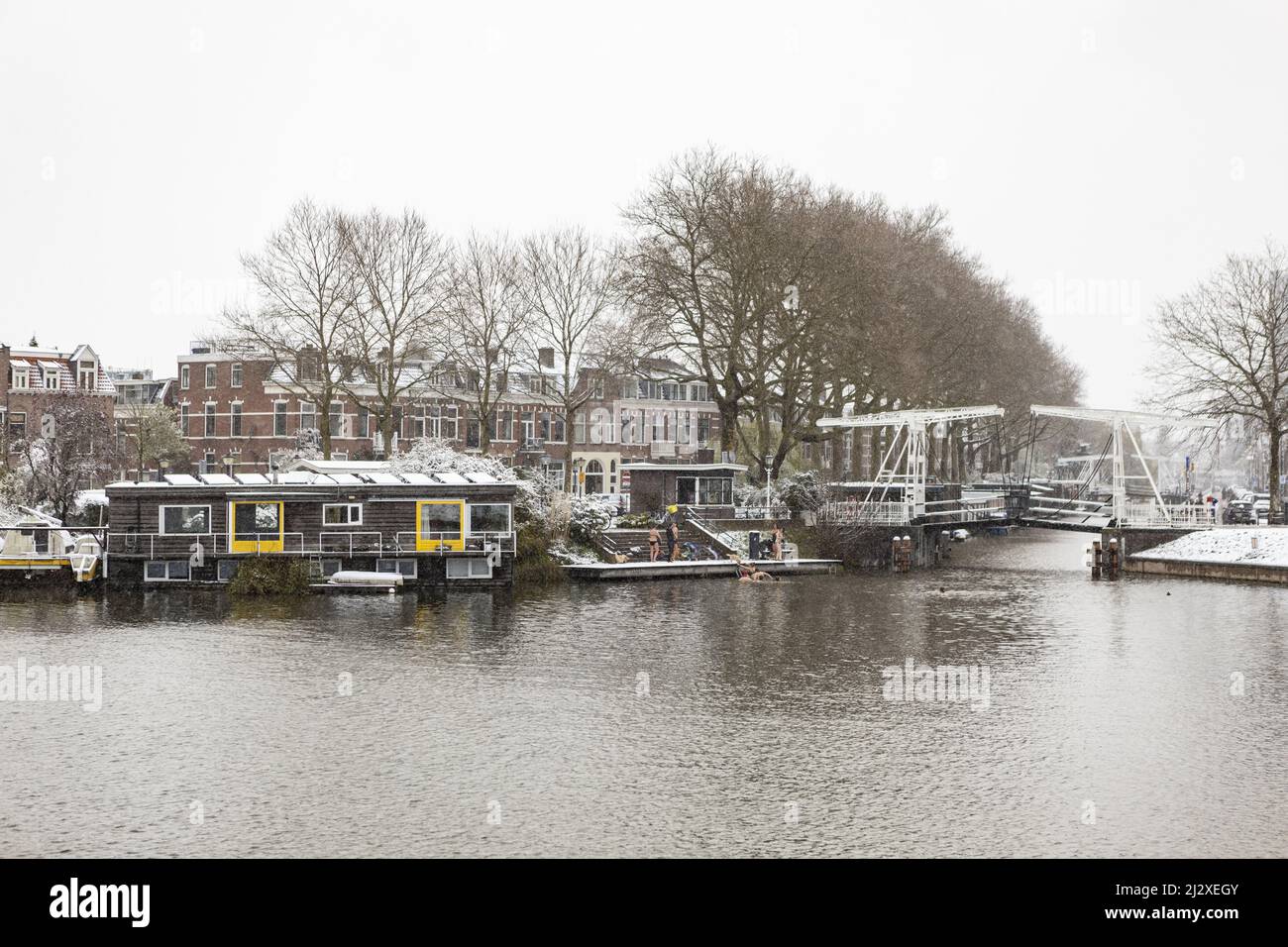 Lovely picturesque canal view with snow on the Dutch floating homes and ...
